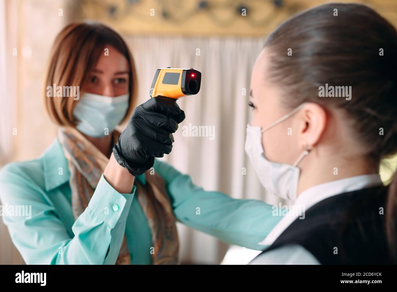 The Manager of a restaurant or hotel checks the body temperature of the ...