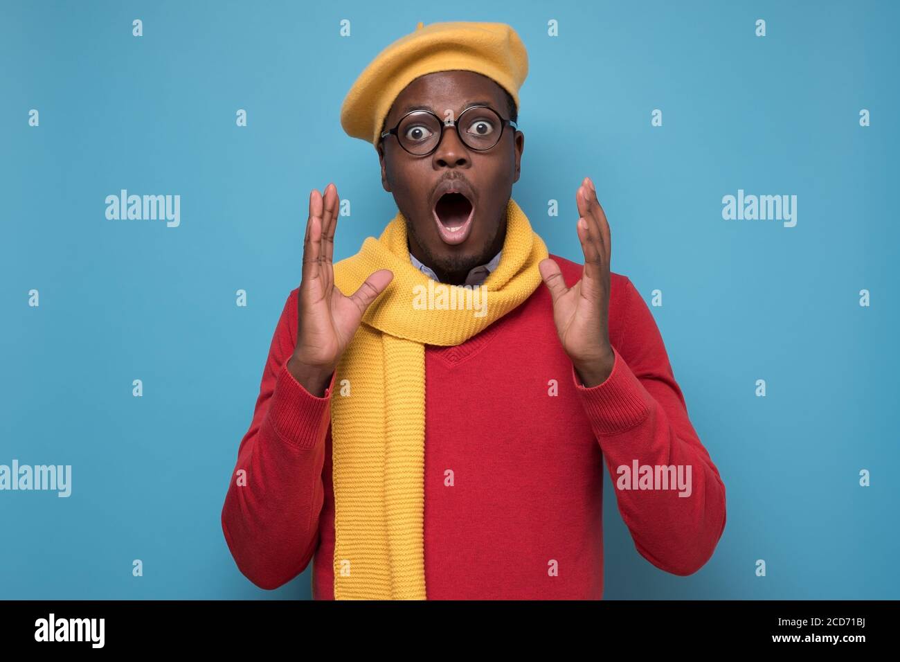 african man screaming in shock, keeping mouth wide open, feeling ...