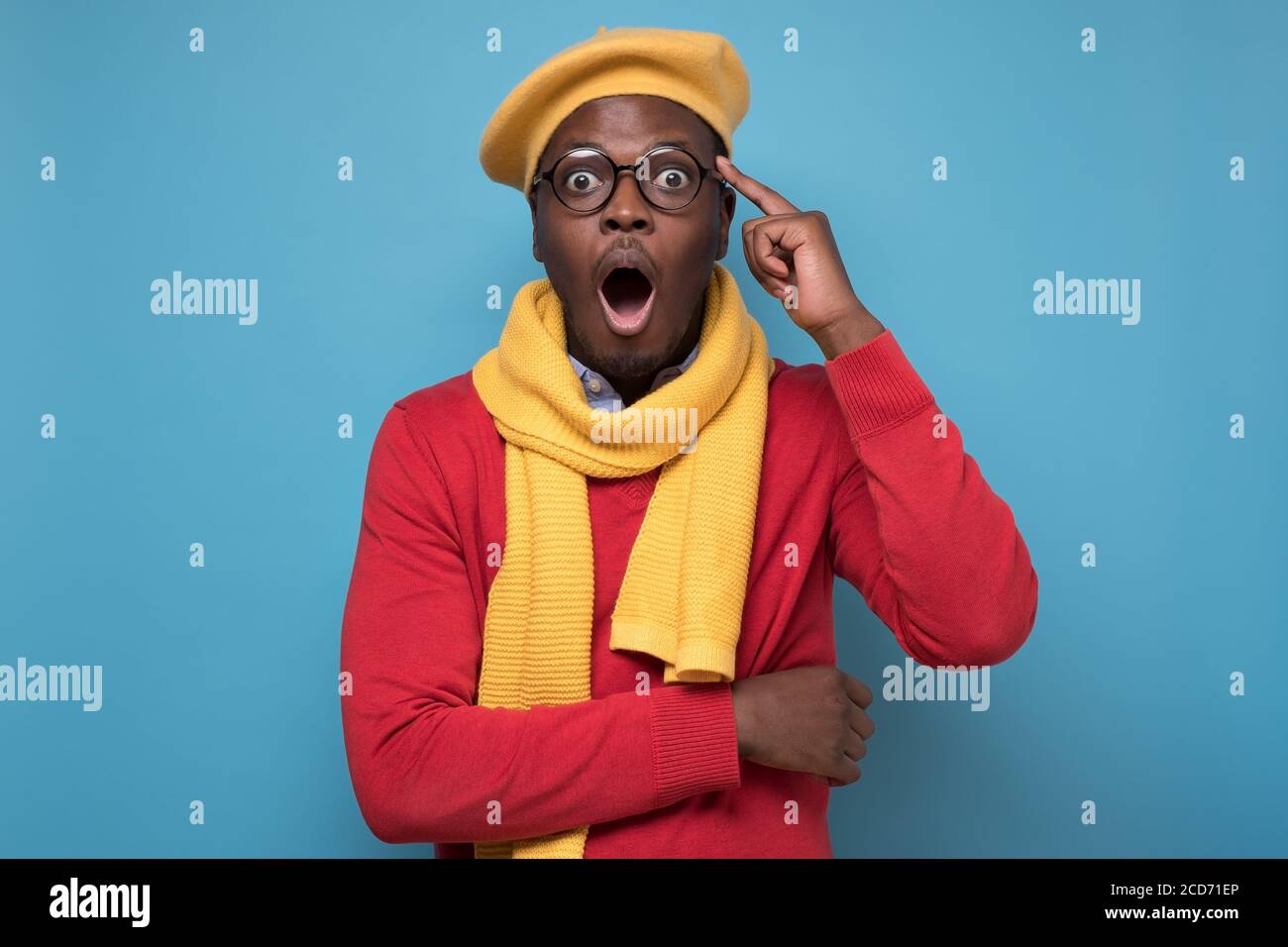 african man screaming in shock, keeping mouth wide open, feeling ...