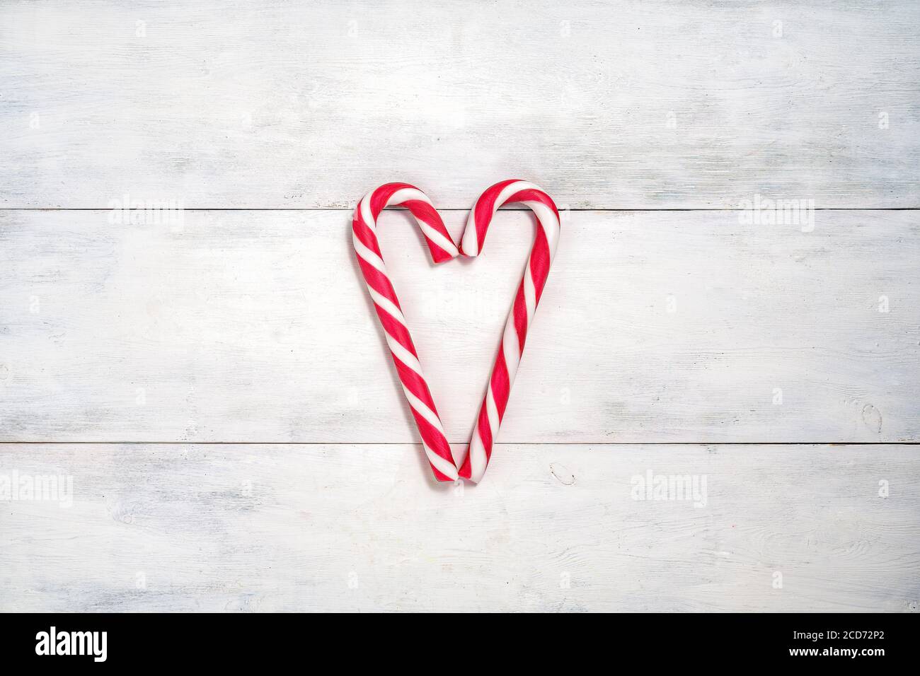 christmas festive background with candy cane. two heart-shaped candy canes Stock Photo - Alamy