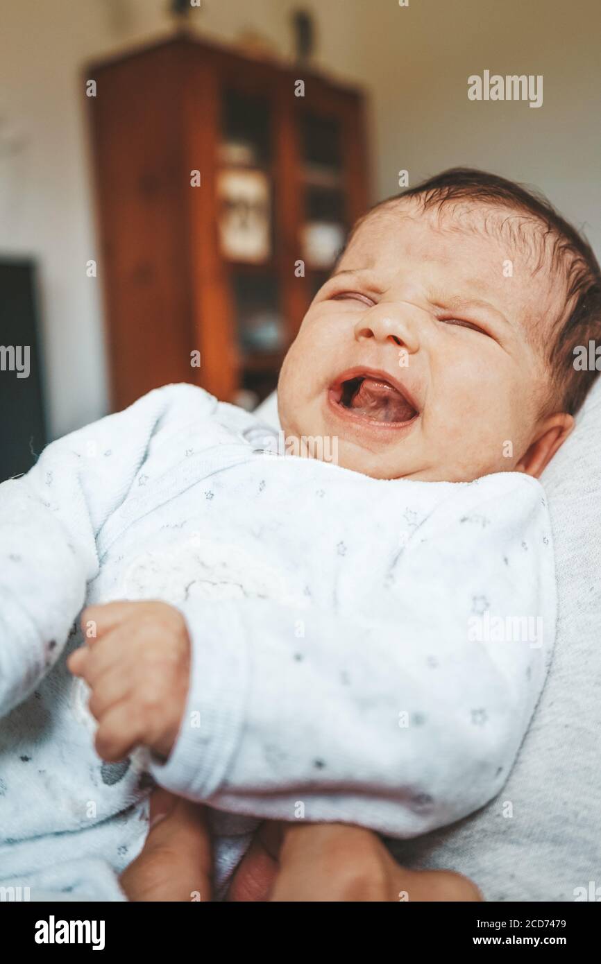 Newborn baby really angry at home Stock Photo - Alamy