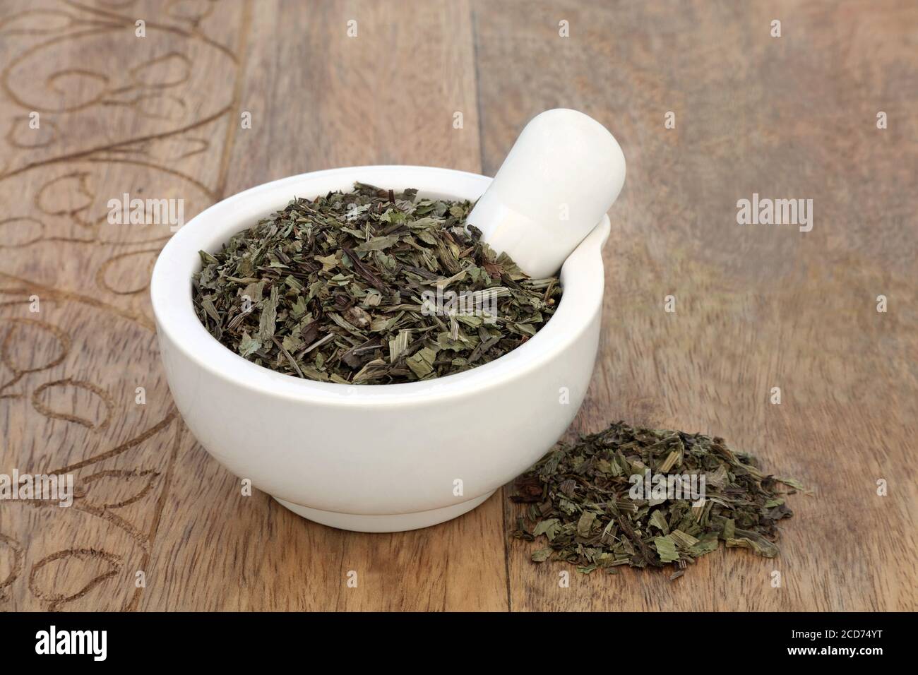 Plantain herb leaf in a mortar used in herbal medicine to treat blood ...