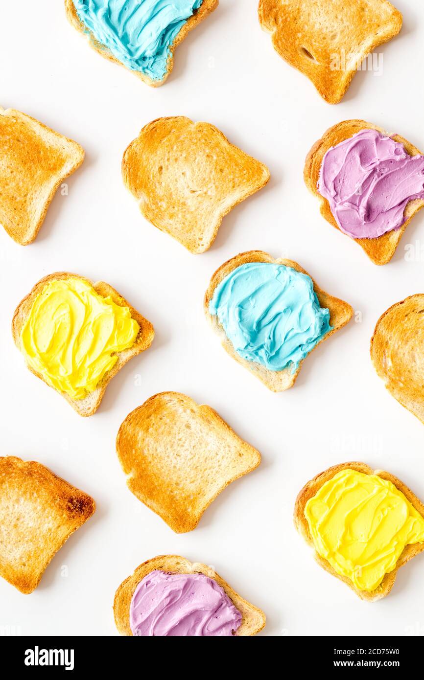 Pattern of toast bread with colored cheese spread. Layout top view ...