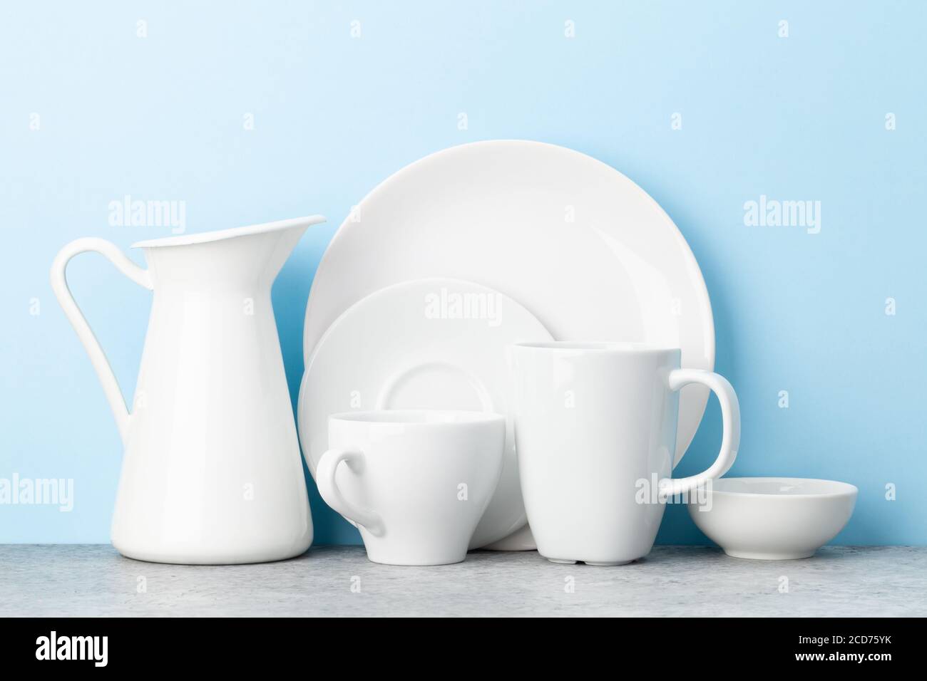 Kitchen utensils and dishes in front of blue background Stock Photo - Alamy