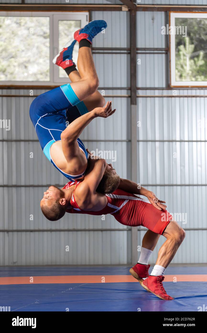 The concept of fair wrestling. Two greco-roman wrestlers in red and ...