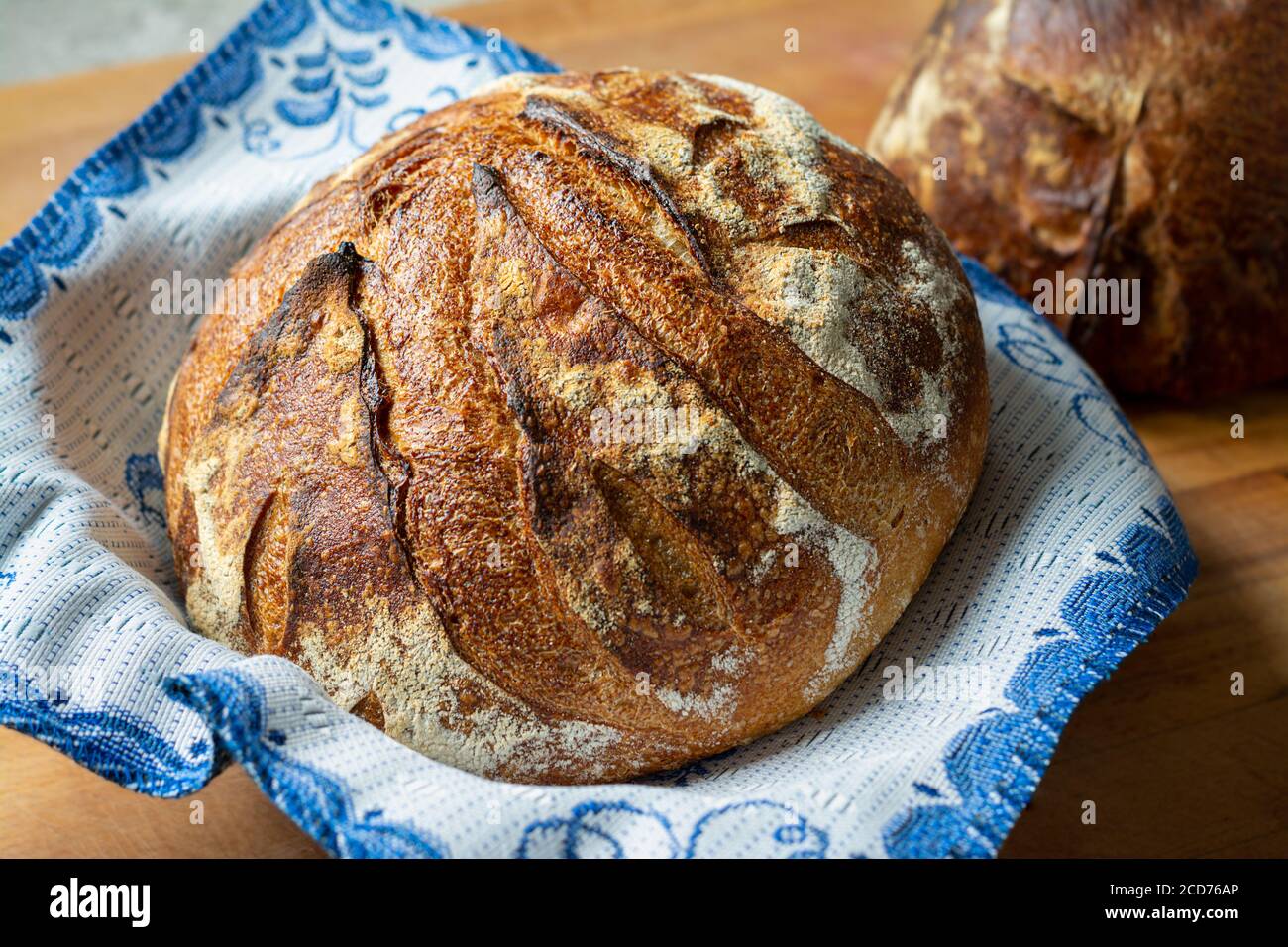 An artisan bread loaf on a blue cloth napkin Stock Photo - Alamy
