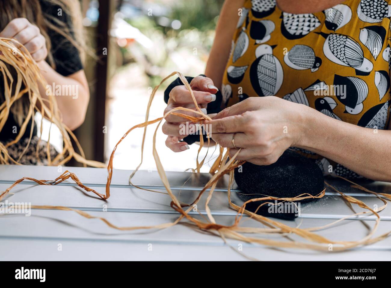 Female weaving basket on the craft workshop. Hands holding the ...