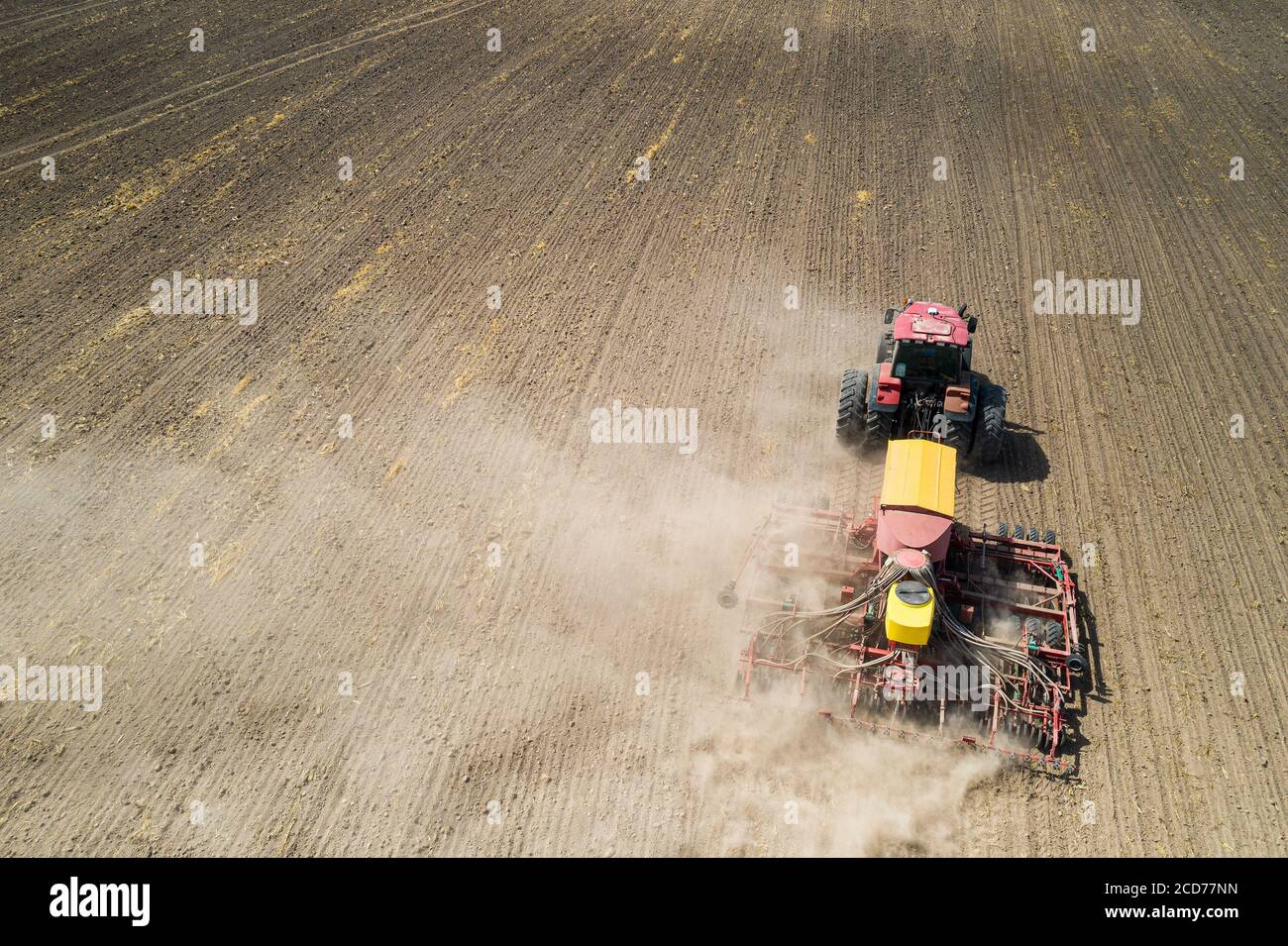 Top view of tractor planting corn seed in field, high angle view drone ...