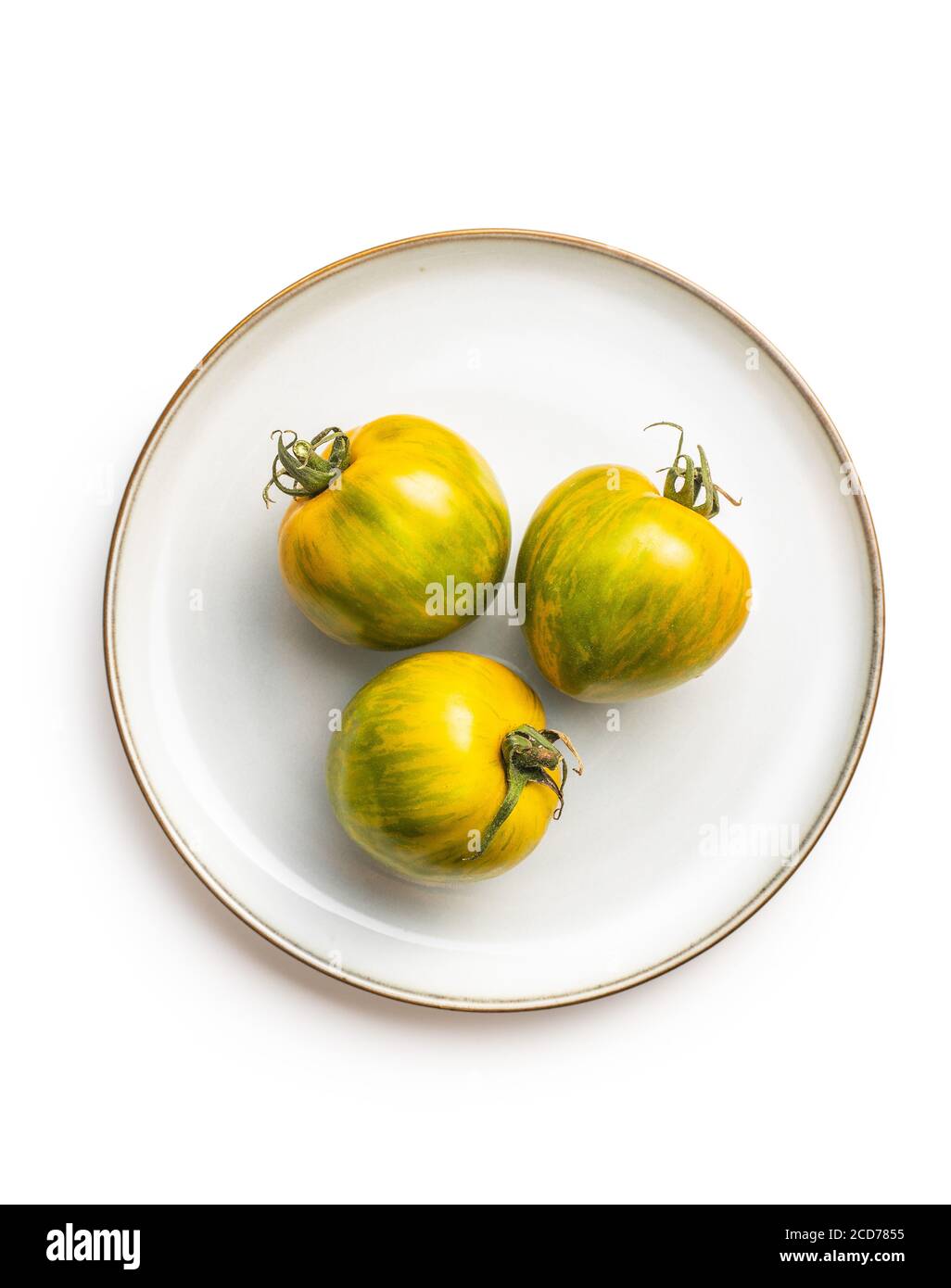 Green zebra tomatoes on plate isolated on white background Stock Photo ...