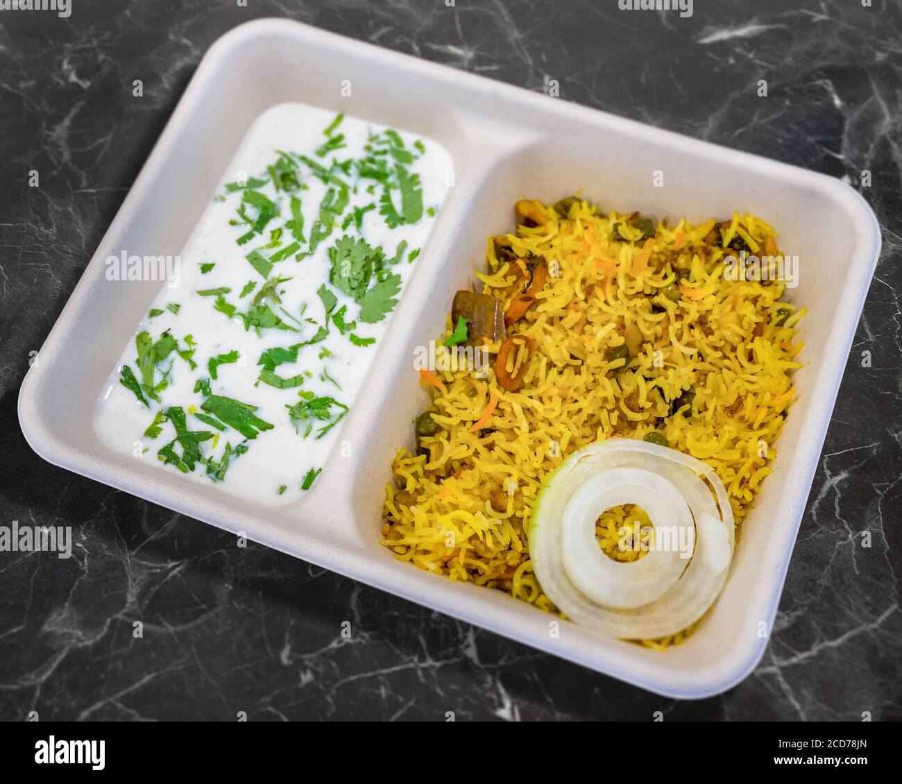 Vegetable Biryani with Raita on a take away container Stock Photo - Alamy