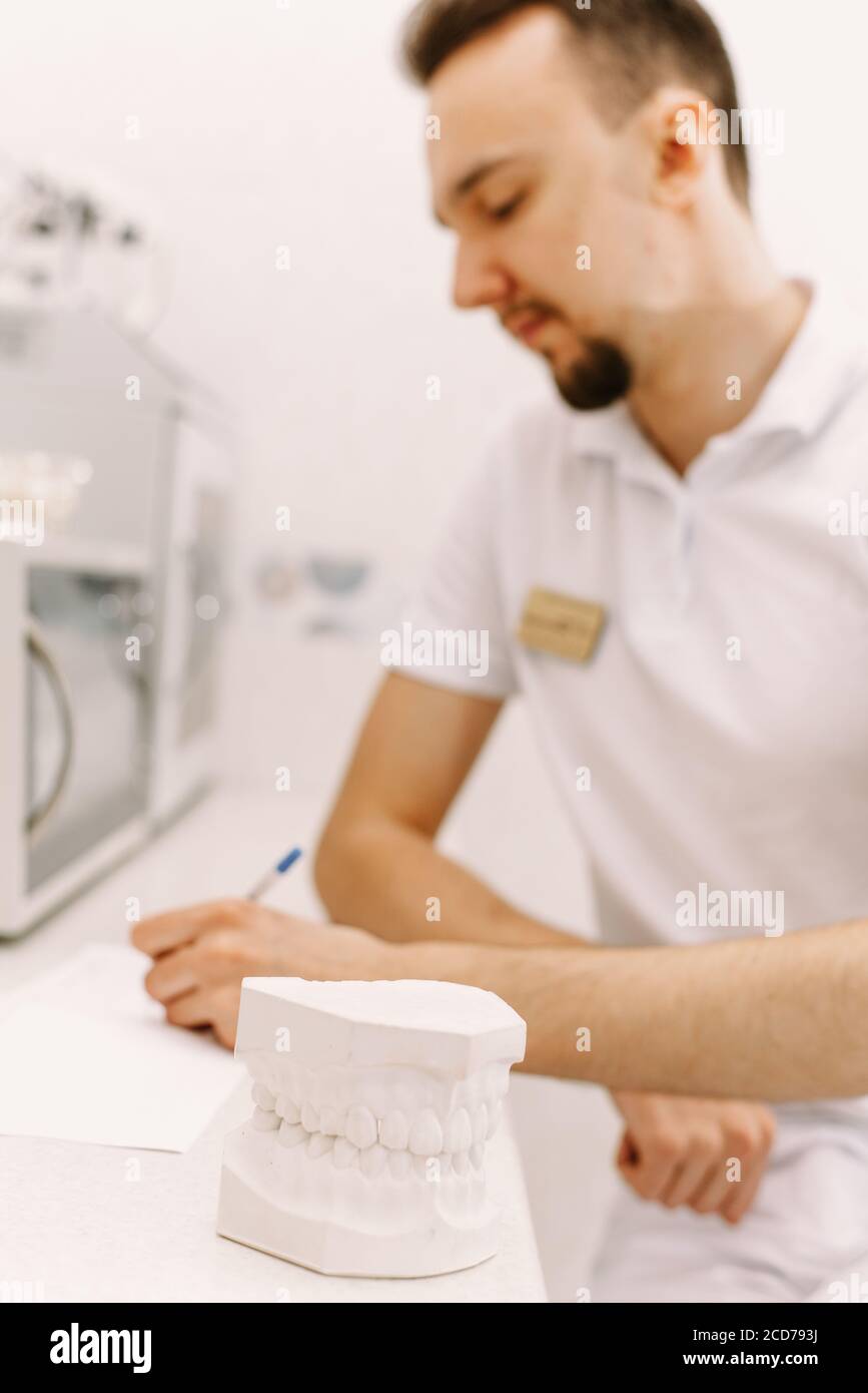 The concept of writing to the dentist. The man writes something on the ...