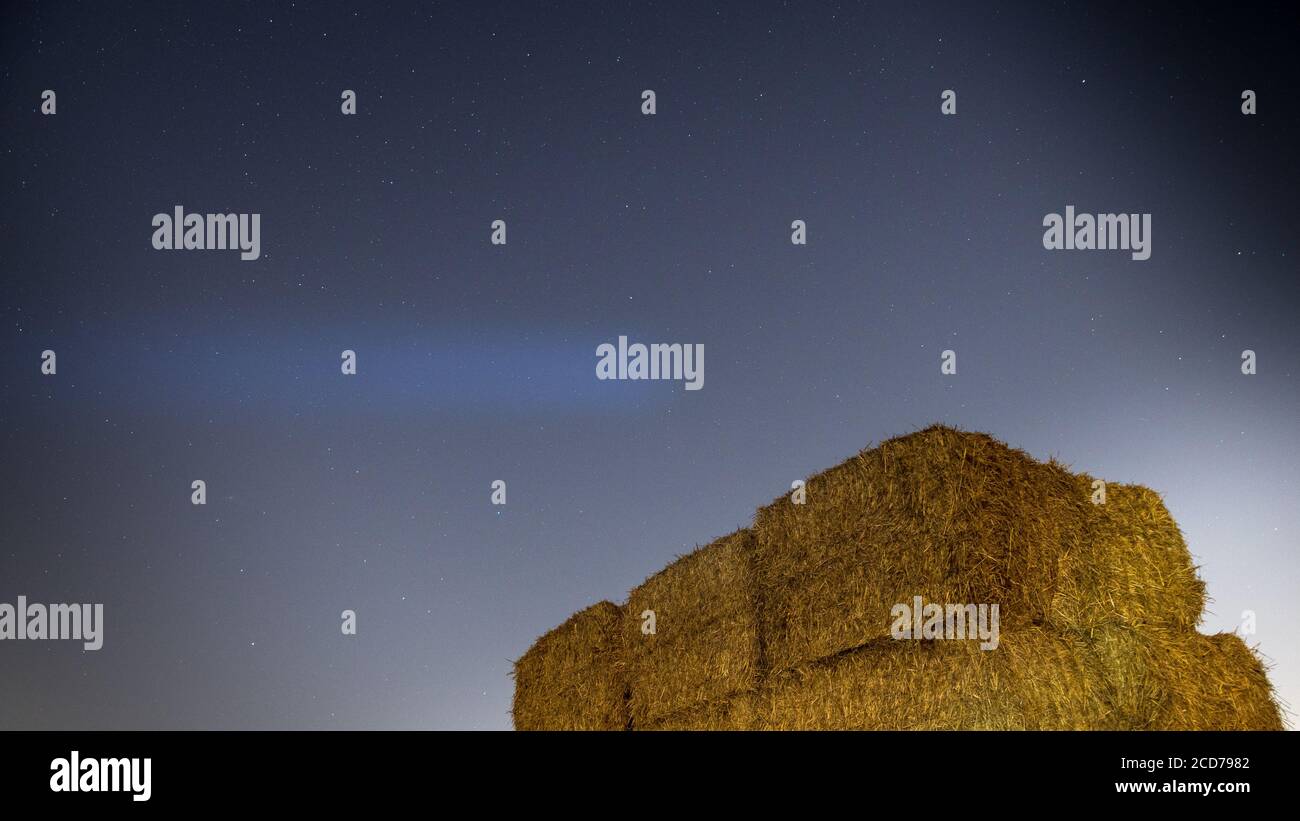 Long exposure night scene of isolated square haystacks on a rural farm ...