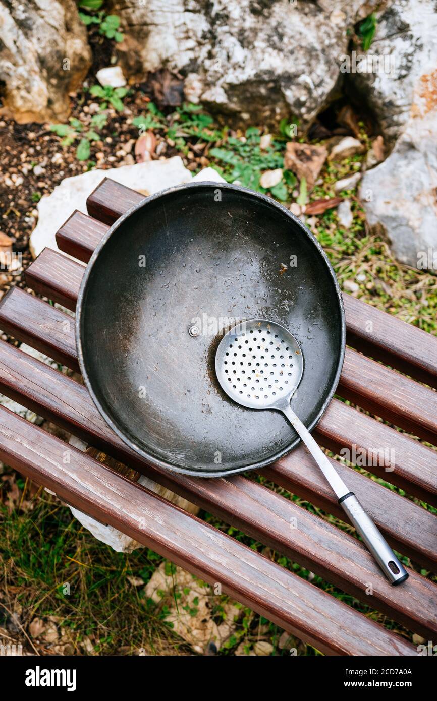 Metal cover for the cauldron with pilaf and metal ladle with holes ...