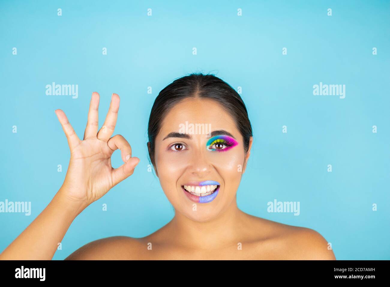 Beauty portrait of female model with vivid makeup on one half of the ...