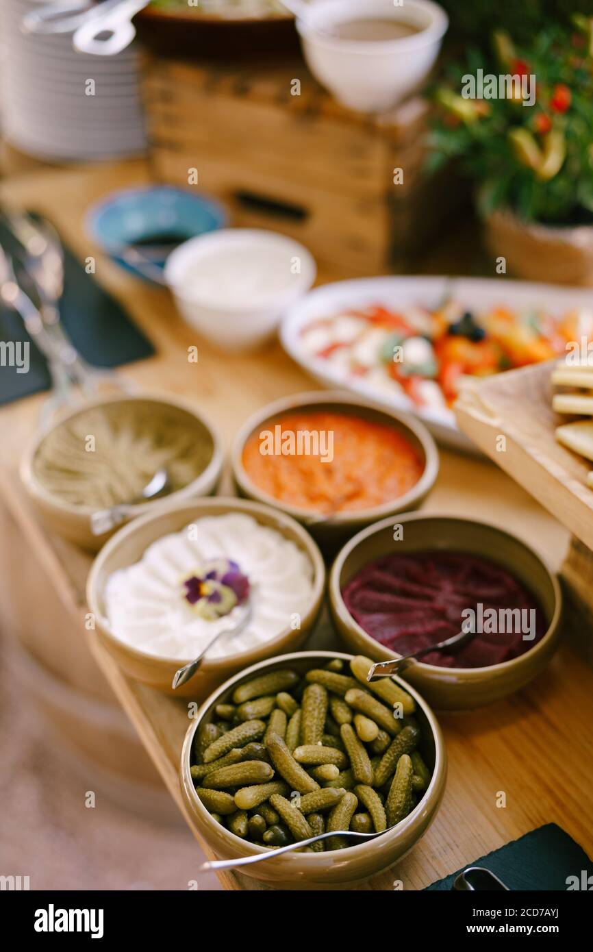 Five plates of food for a banquet on the table with a tomato appetizer ...