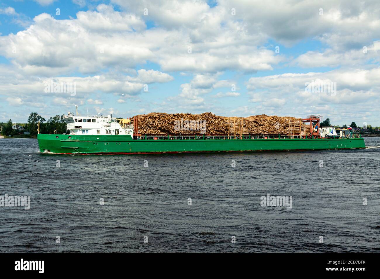 The ship is carrying logs along the river Stock Photo - Alamy
