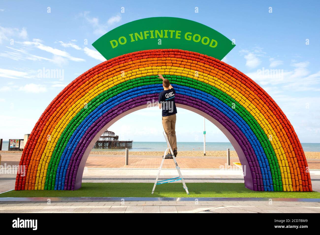Finishing touches are made to a 4x7 metre rainbow arch, made entirely ...