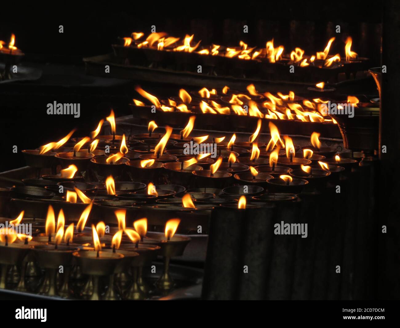 Holy glowing flame of lamp or group of diya glowing at night symbolized ...