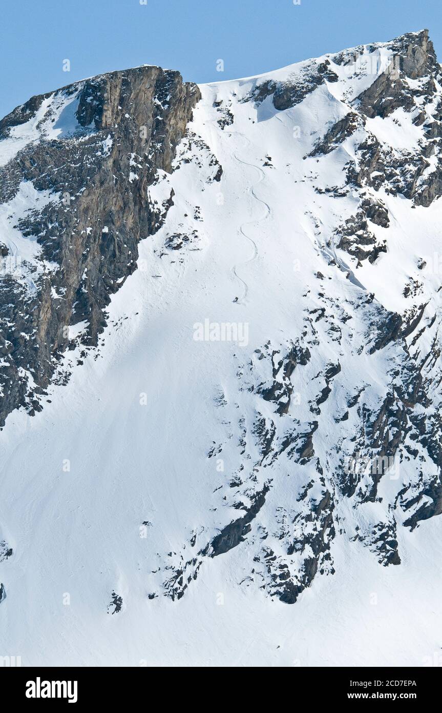 Adventurer riding steep slope in backcountry Stock Photo - Alamy