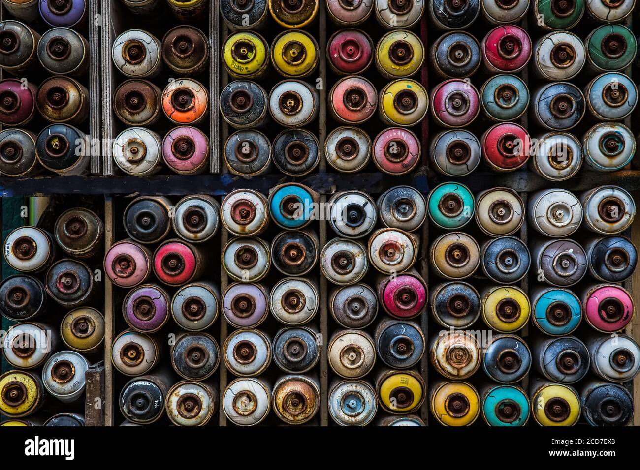 Colorful spray graffiti paint bottles stacked to be a background image ...