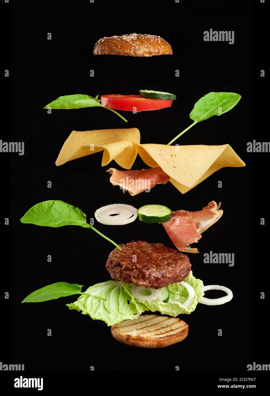 levitating cheeseburger ingredients: juicy meat cutlet, cheddar cheese ...