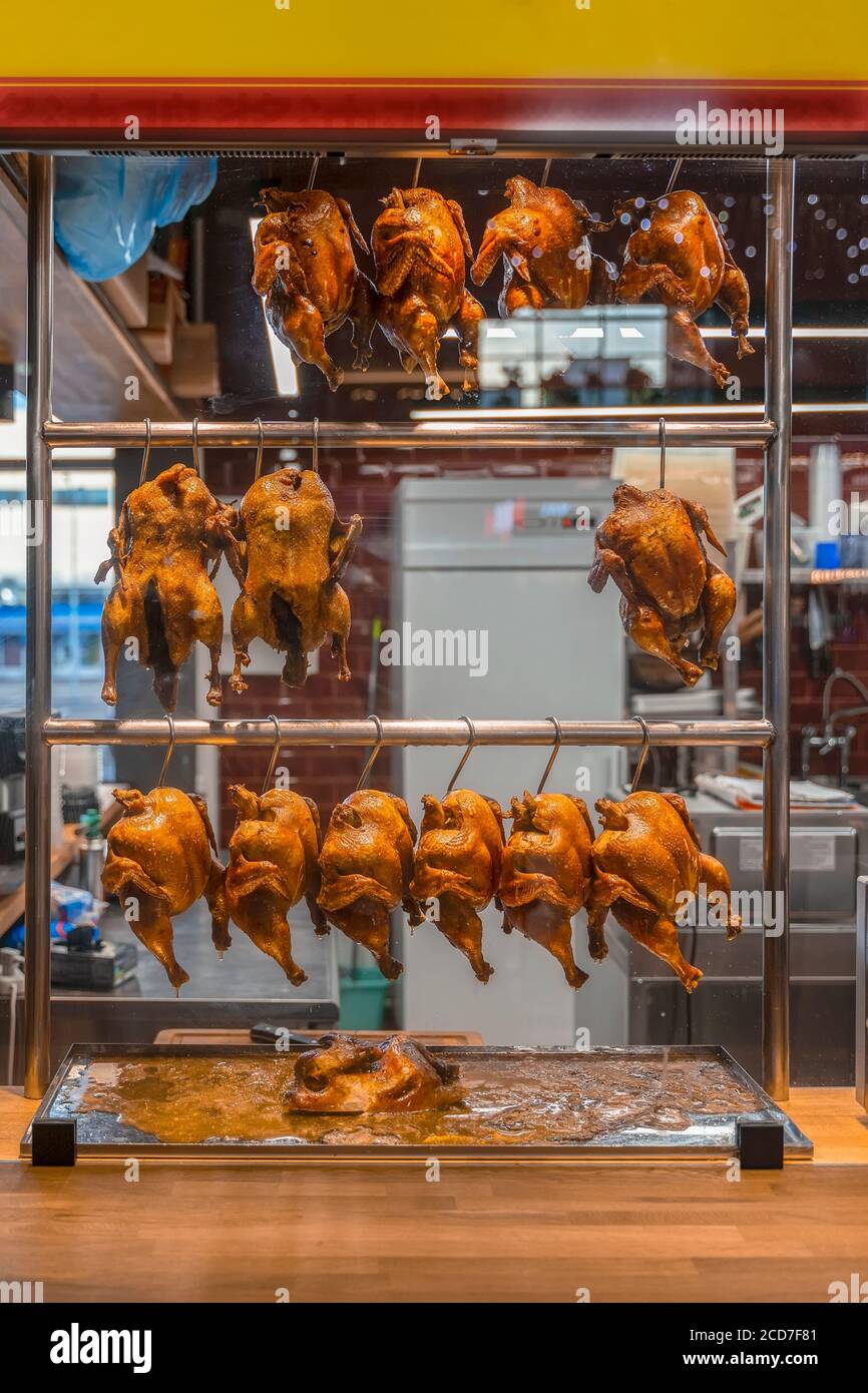 Roasted ducks and chickens hanging on shopping window, rack showcase in ...