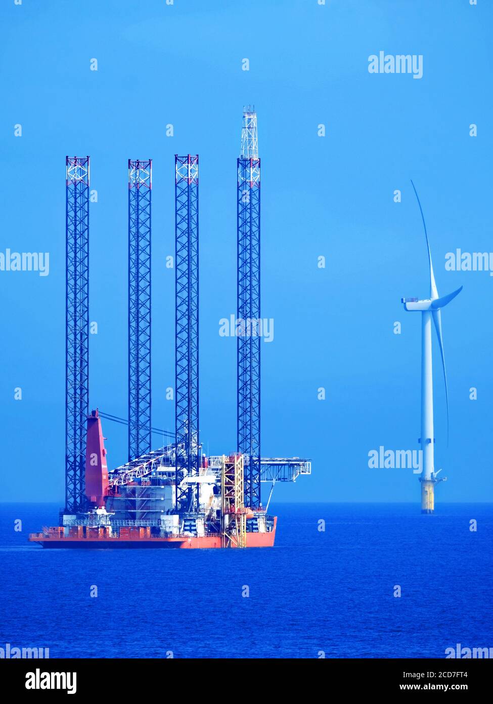 Jack up rig GMS Endeavour and a wind turbine in the North sea in clear ...