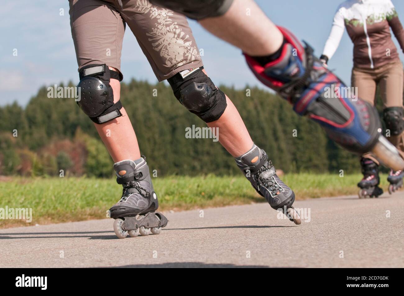 Group doing a tour on roller blades on a small way in countryside Stock ...