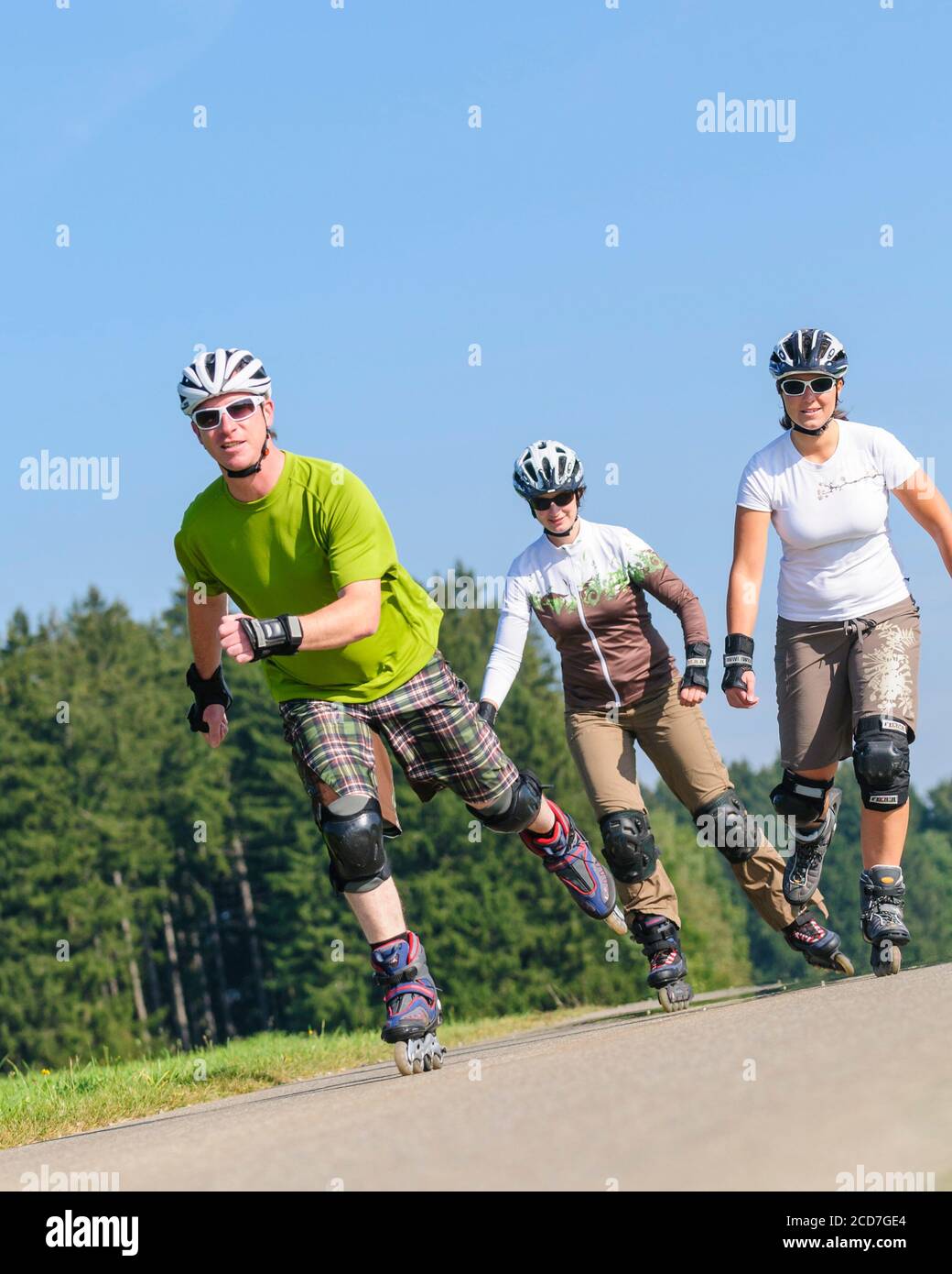Group doing a tour on roller blades on a small way in countryside Stock ...
