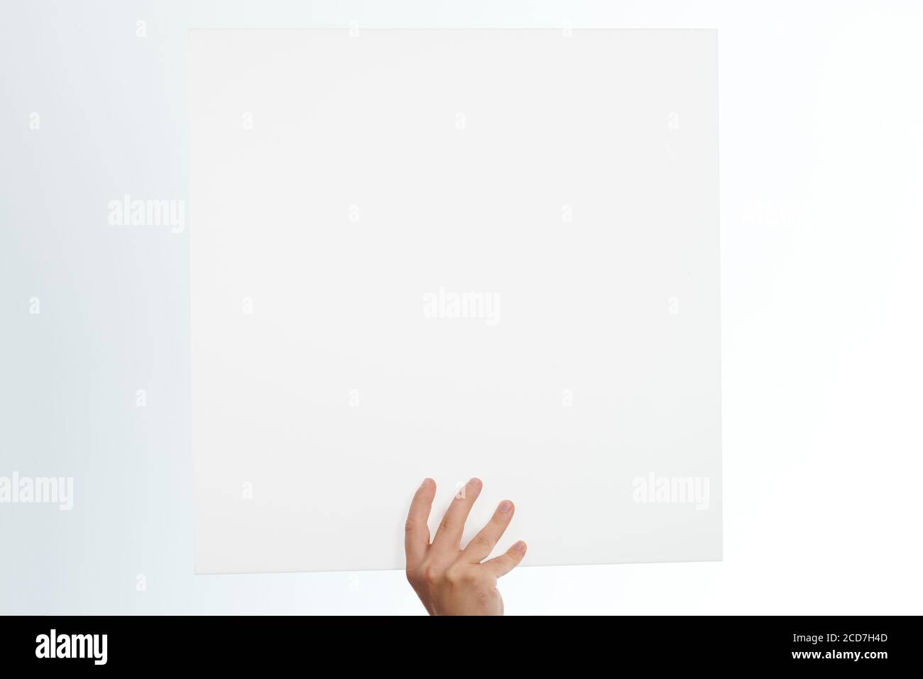 One hand hold white board isolated on studio background Stock Photo - Alamy