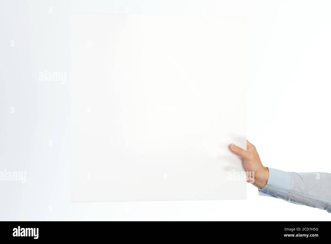 Hand hold square poster isolated on white studio background Stock Photo ...