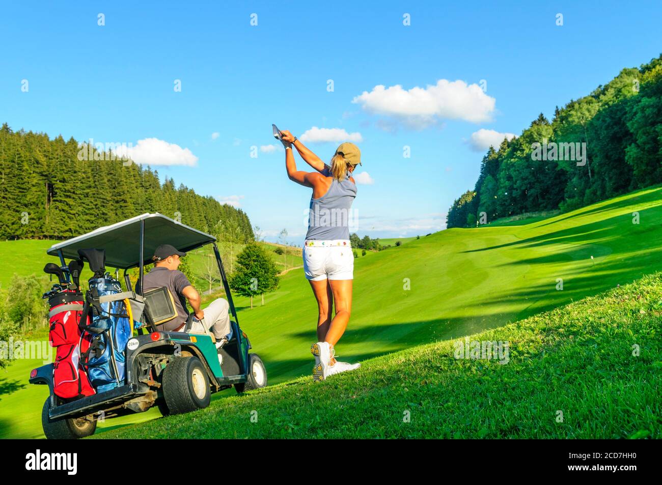 Sporty woman playing golf Stock Photo - Alamy