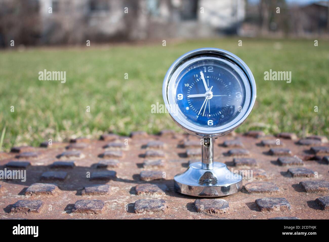 clock on the green grass Stock Photo - Alamy