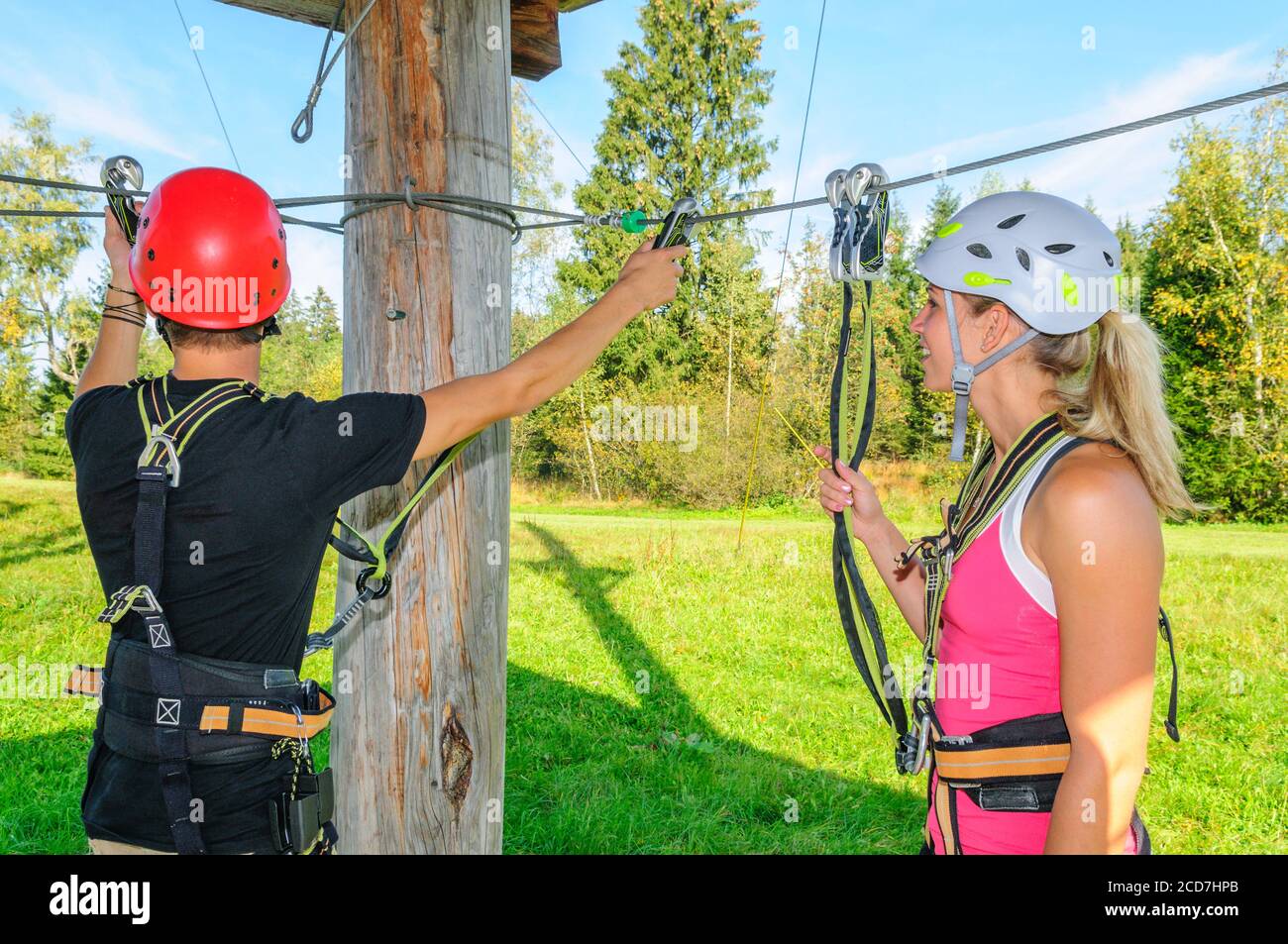 Young people doing exercises in high rope course at a sunny day Stock ...