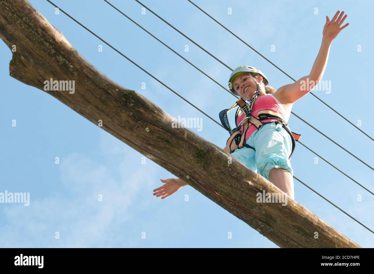 Young people doing exercises in high rope course at a sunny day Stock ...