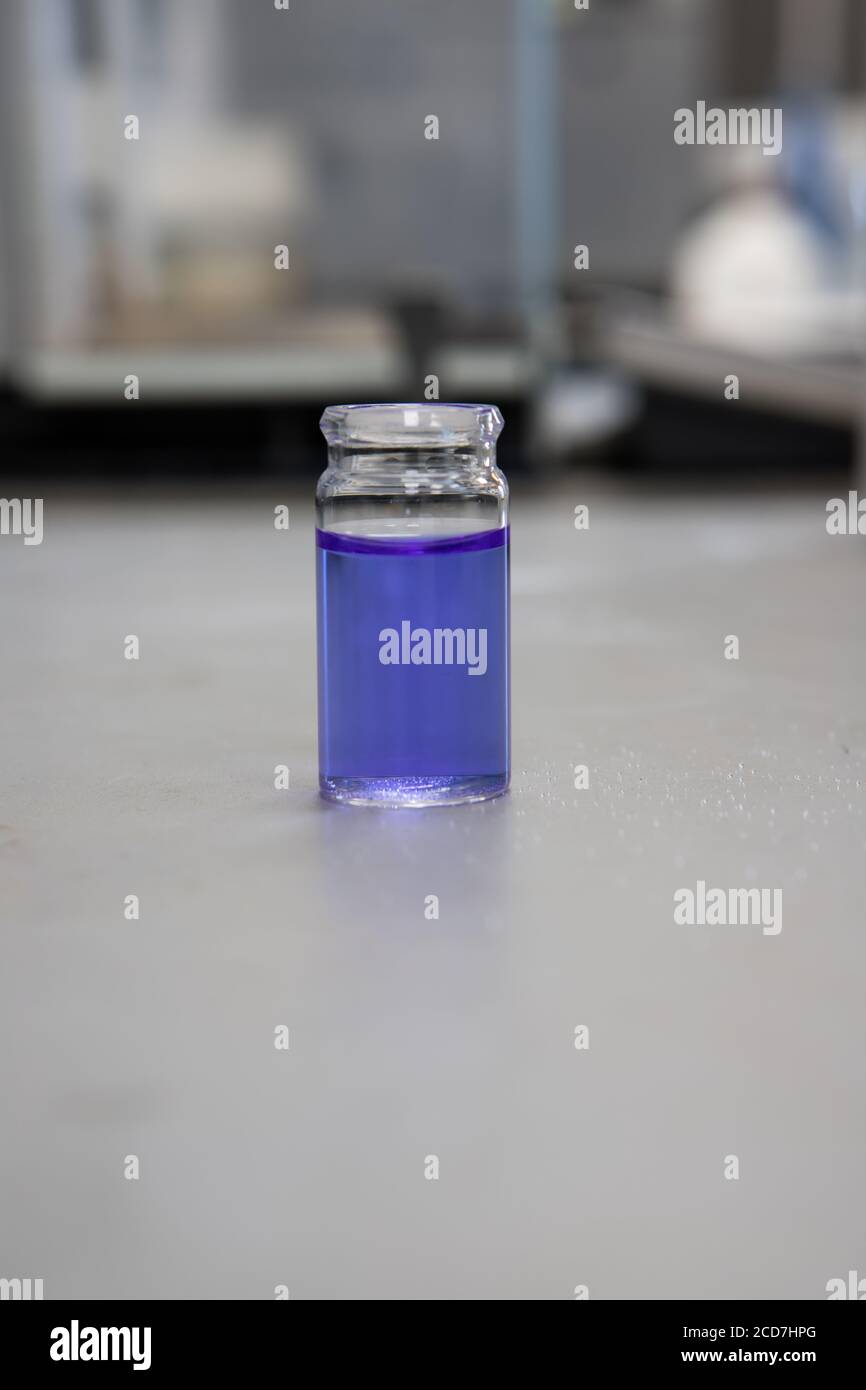 Purple chemical solution in a science laboratory. Analytical chemistry ...