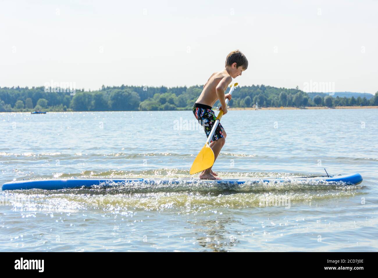 Young boy has fun on SUP-Board on the Altmühlsee Stock Photo - Alamy