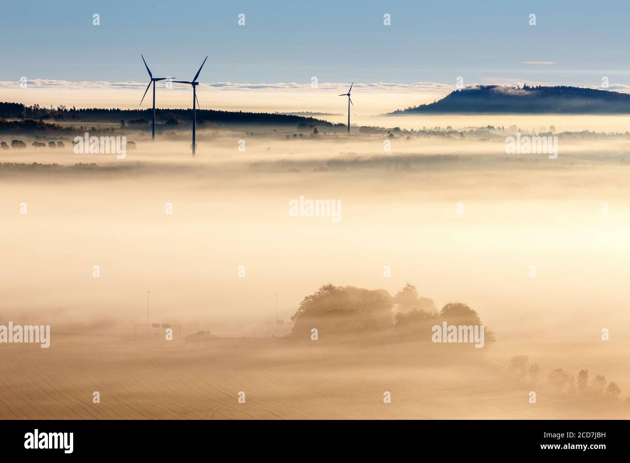 Morning fog over an agricultural landscape with wind turbines Stock ...