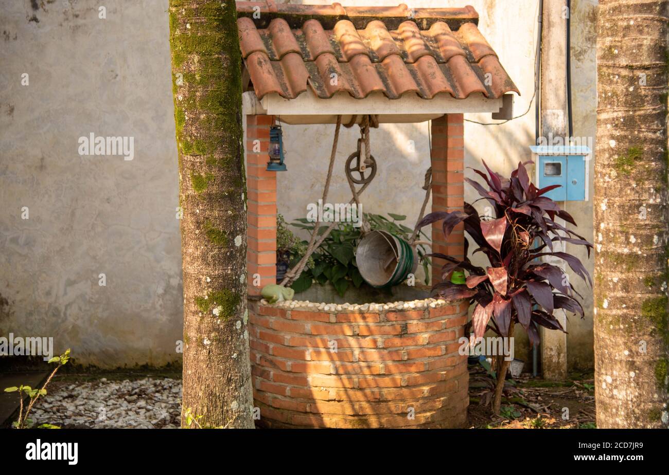 Replica of a fresh water pit, a bucket and other props in the garden of ...