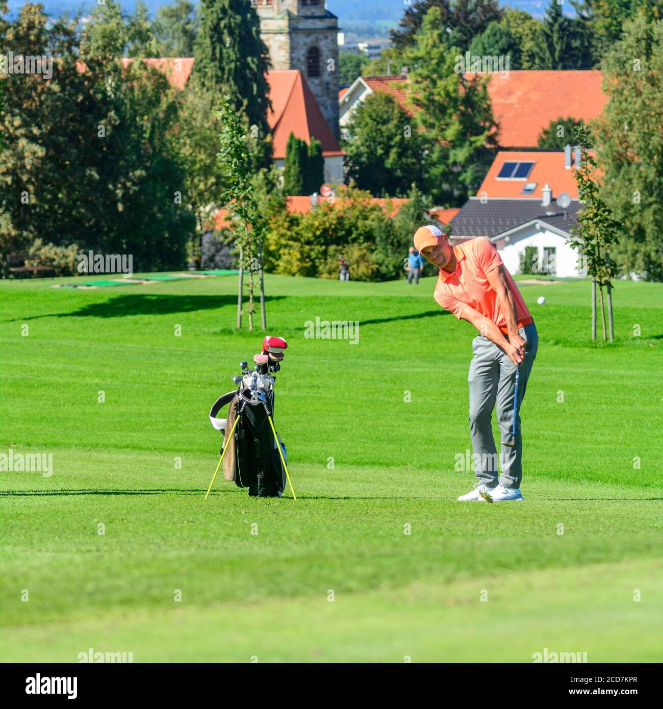 Golf player chipping ball to green Stock Photo - Alamy