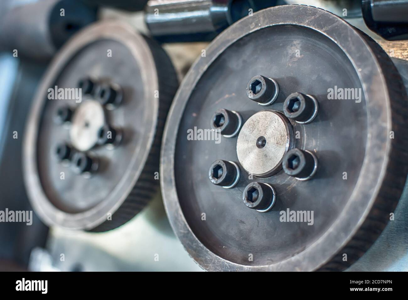 Close up detail view of mechanical nut transport system in industrial ...