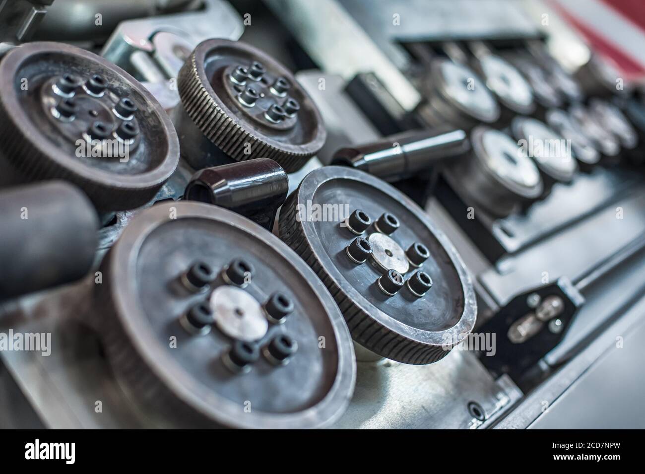 Close up detail view of mechanical nut transport system in industrial ...