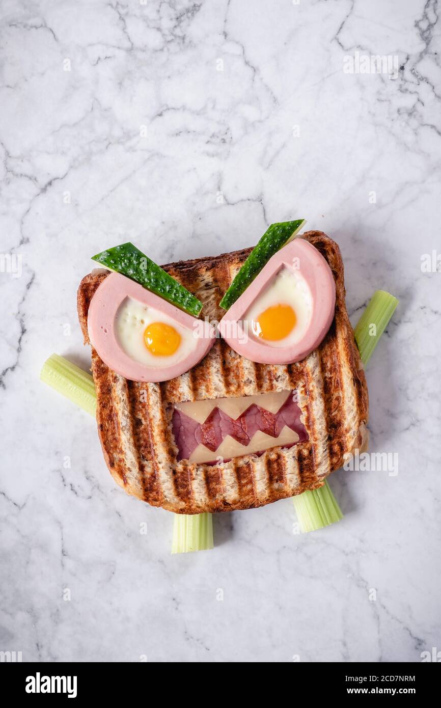 Monster sandwich with sausage, eggs and cheese on plate Stock Photo - Alamy