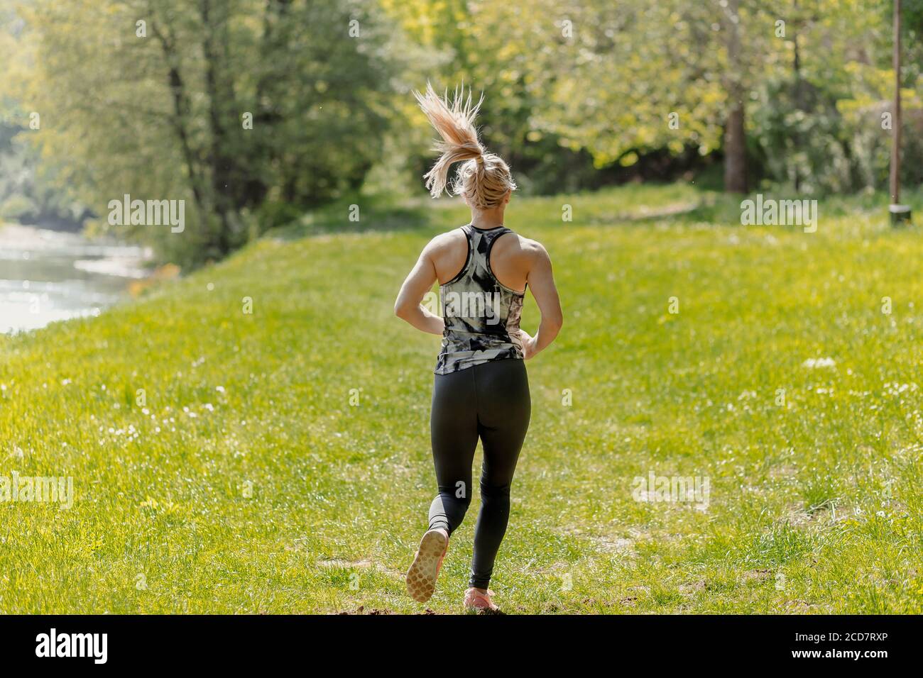 Back view photo of young blonde girl wearing sportswear running in the ...