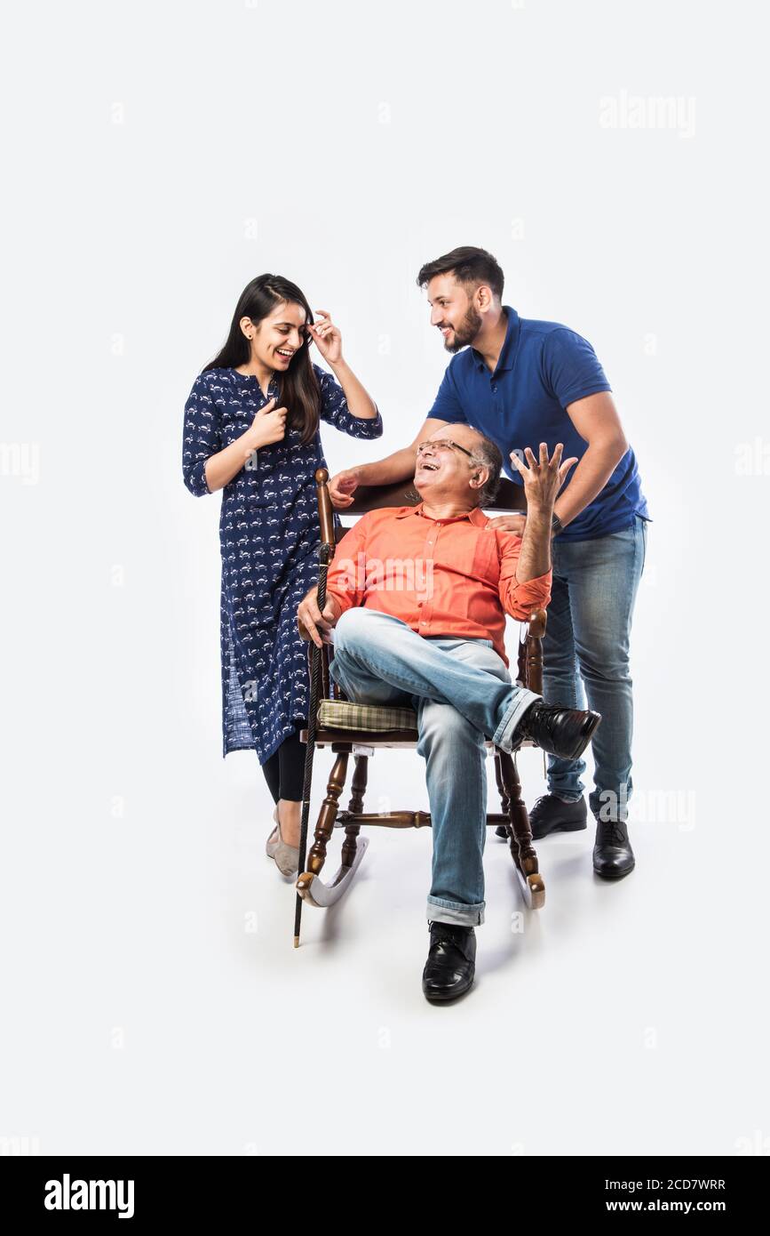 Indian old man or father with young son and daughter, sitting over ...