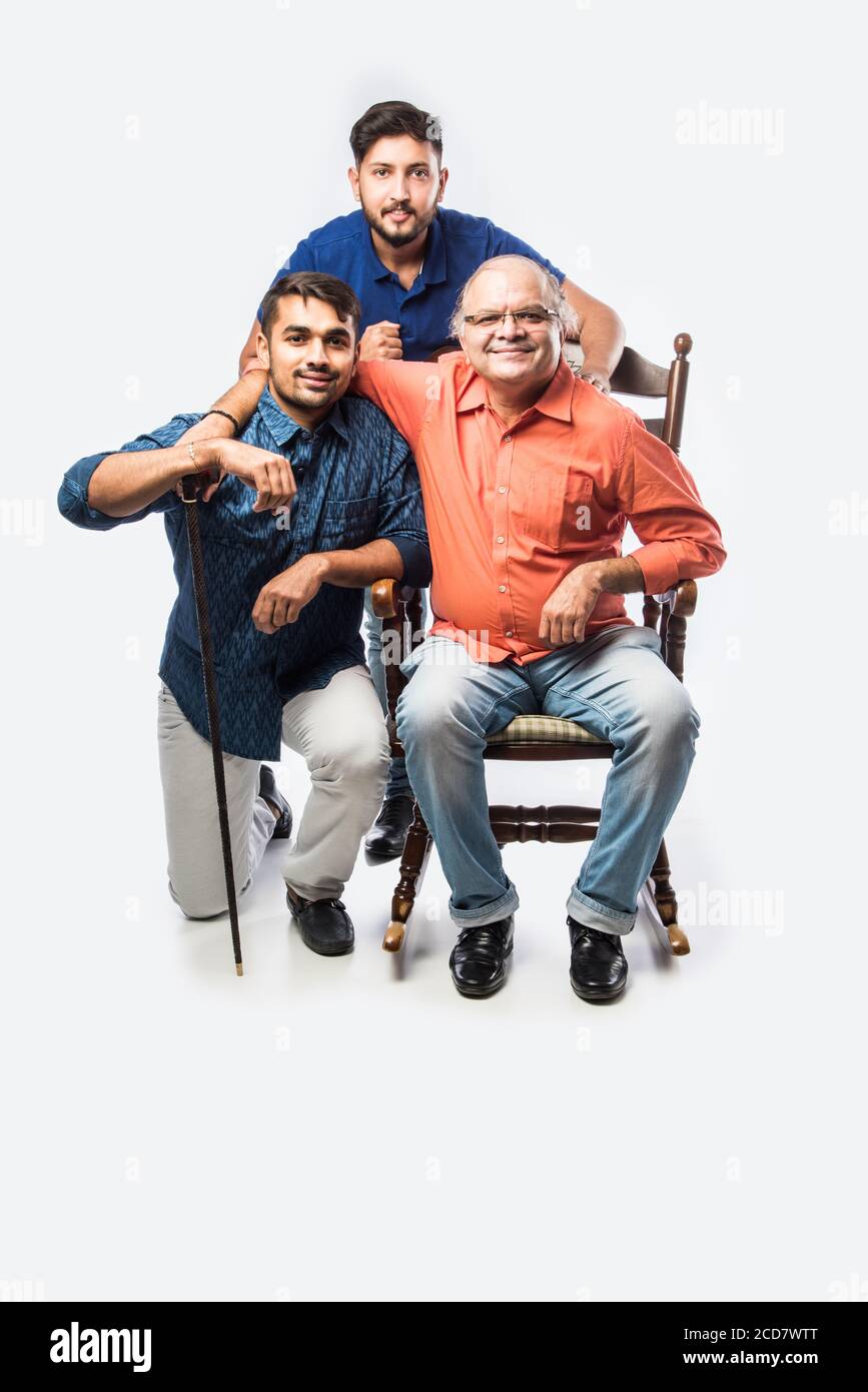 Indian old man or father with young son and daughter, sitting over ...