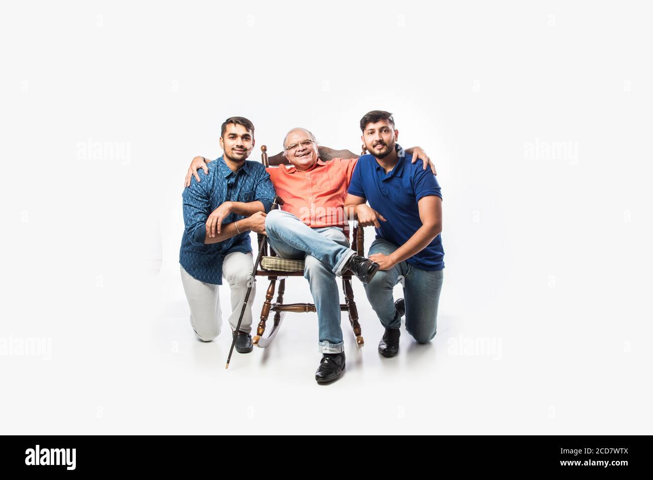 Indian old man or father with young son and daughter, sitting over ...