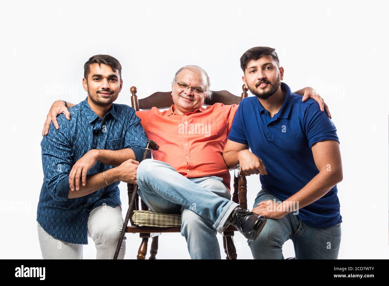 Indian old man or father with young son and daughter, sitting over ...