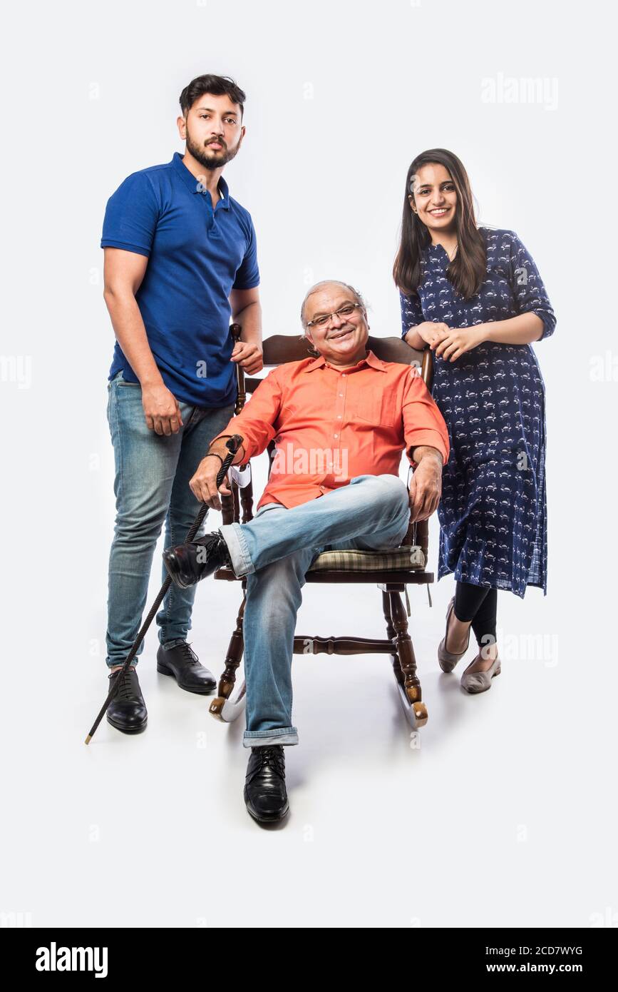 Indian old man or father with young son and daughter, sitting over ...