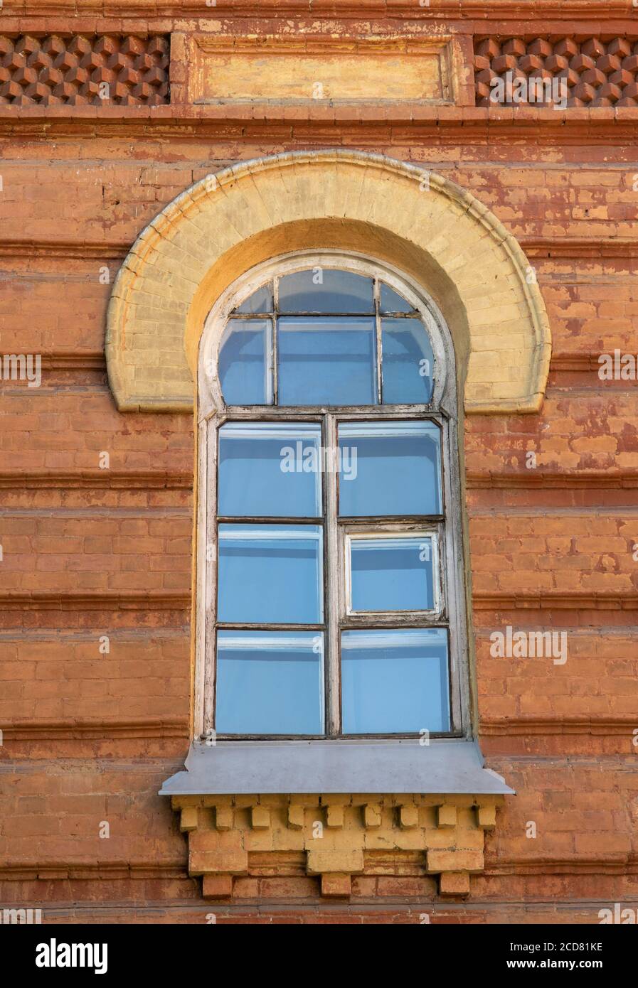 old wooden window in a brick building. red brick wall and wooden window ...